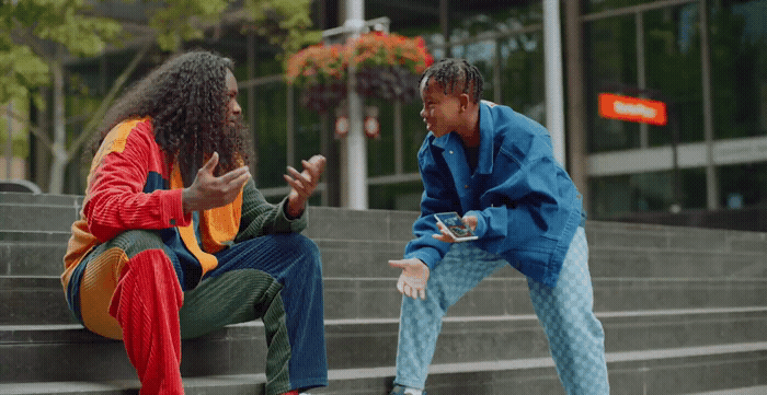 Two people sitting on steps talking to each other – Image on Kive.ai