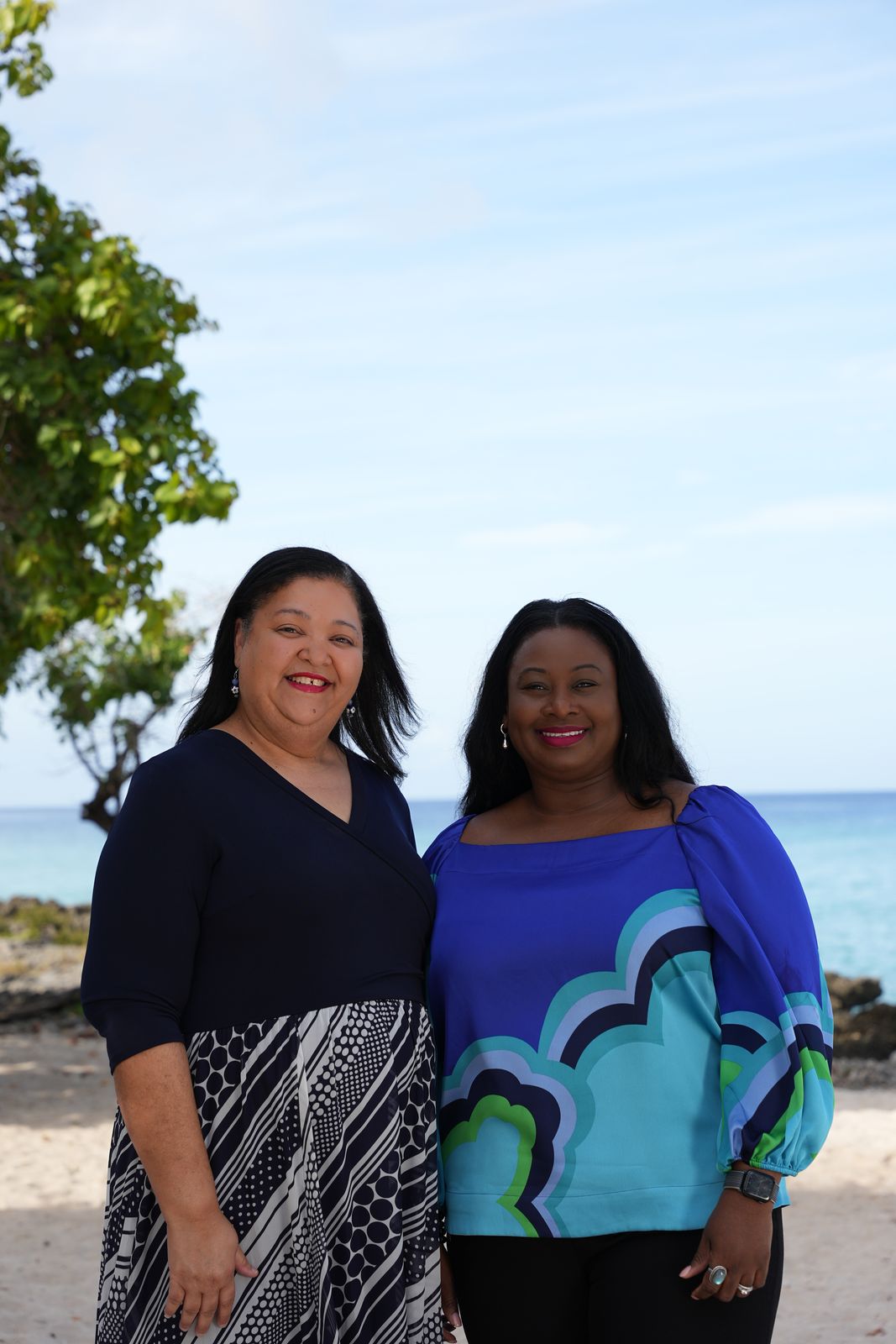 Two women standing next to each other on a beach – Image on Kive.ai