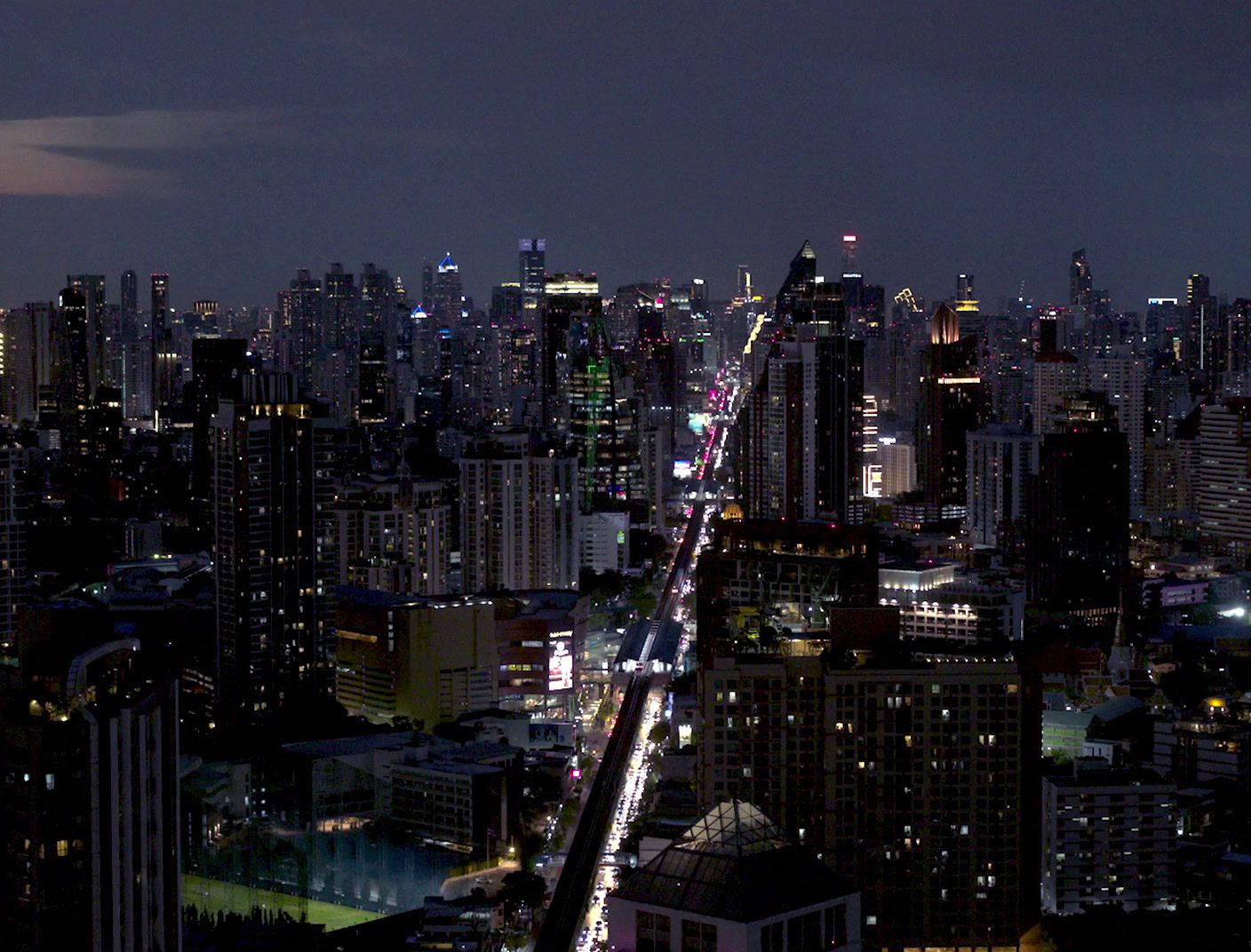 A city at night with a very long line of traffic | Kive
